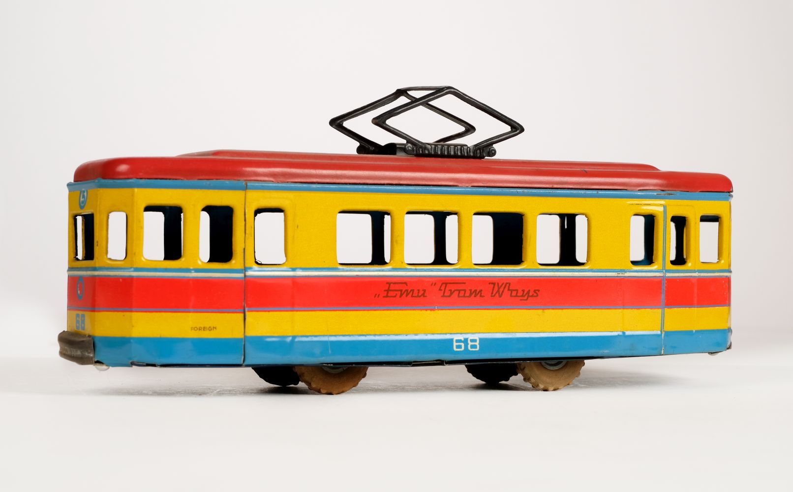 Lot 10 - Trams. A collection of toy trams and cars etc.