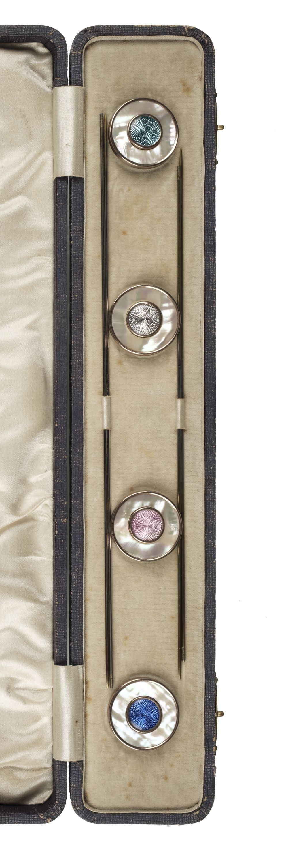 Lot 94 - Hat pins. A boxed set of enamel and mother of