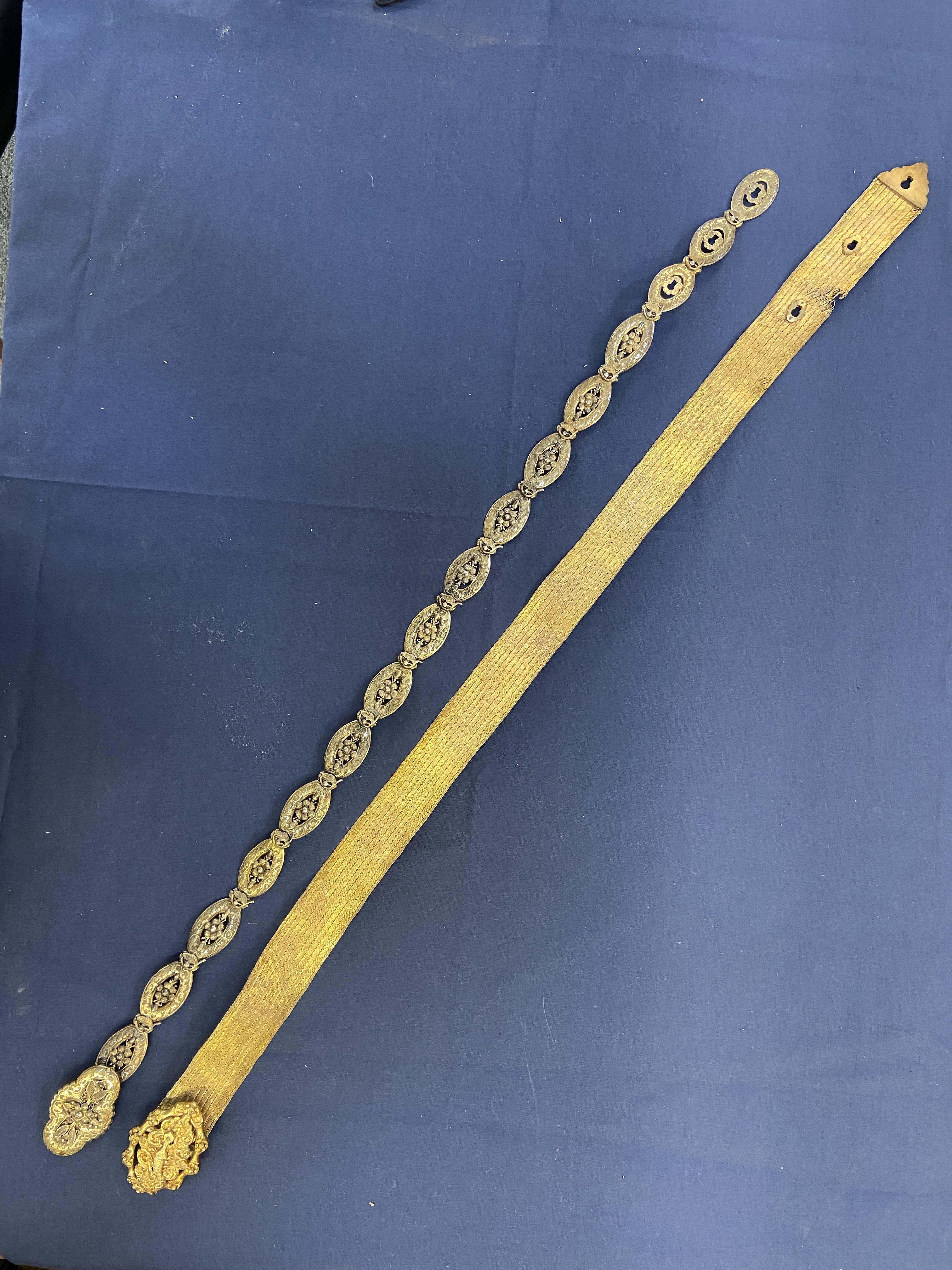 Lot 73 - Belts. A Middle Eastern white metal and gilt