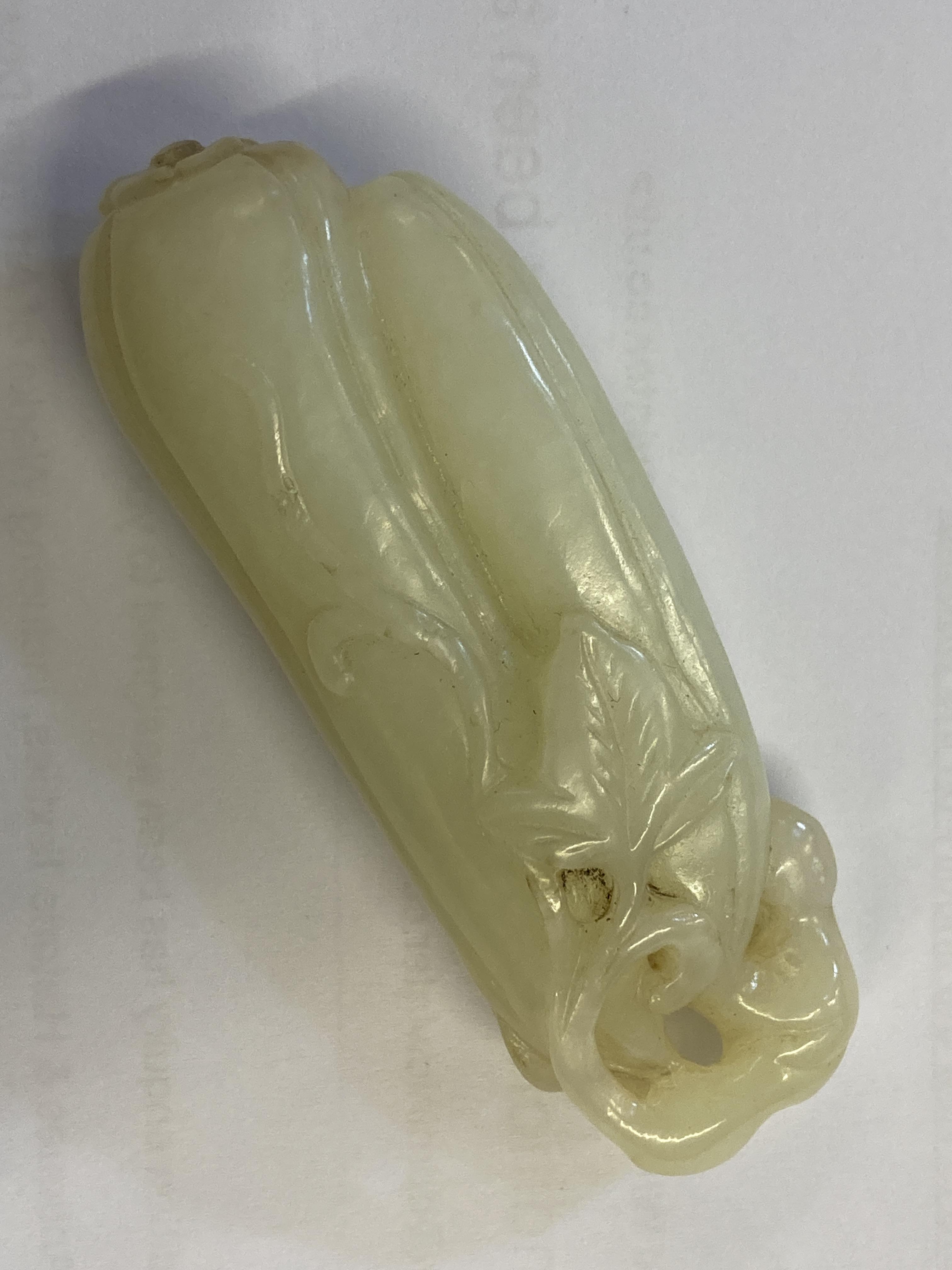 Lot 488 - Jade. A Chinese white jade fruit carving