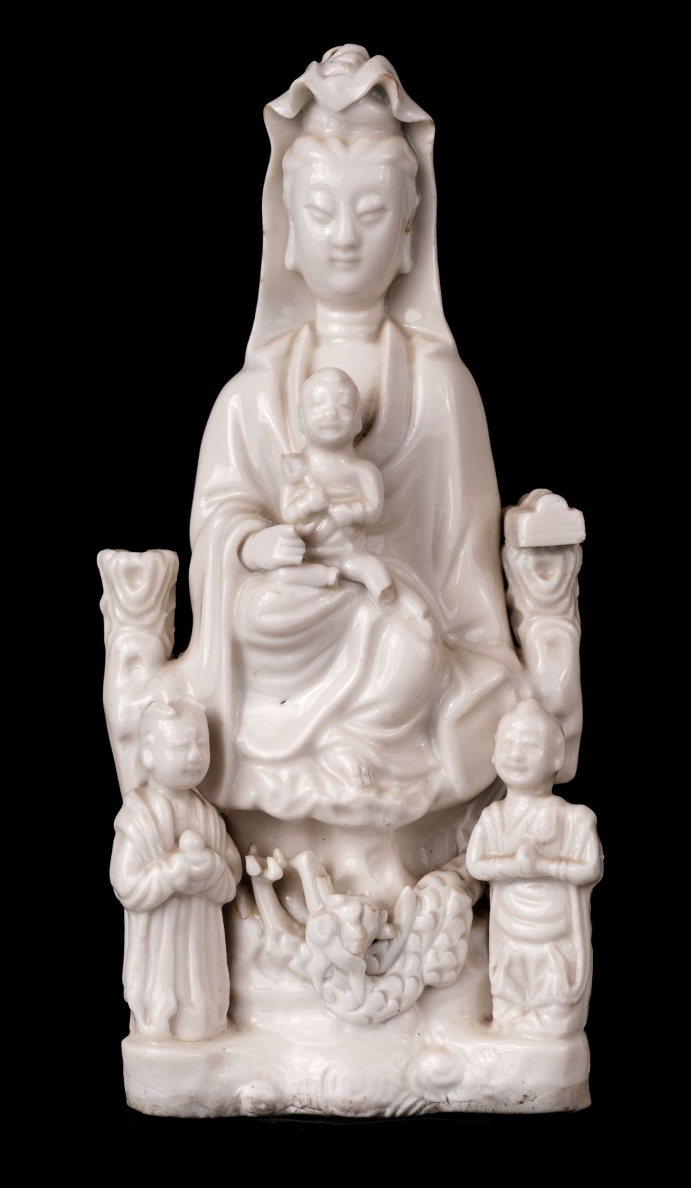 Lot 8 - Blanc de Chine Guanyin porcelain figural group,