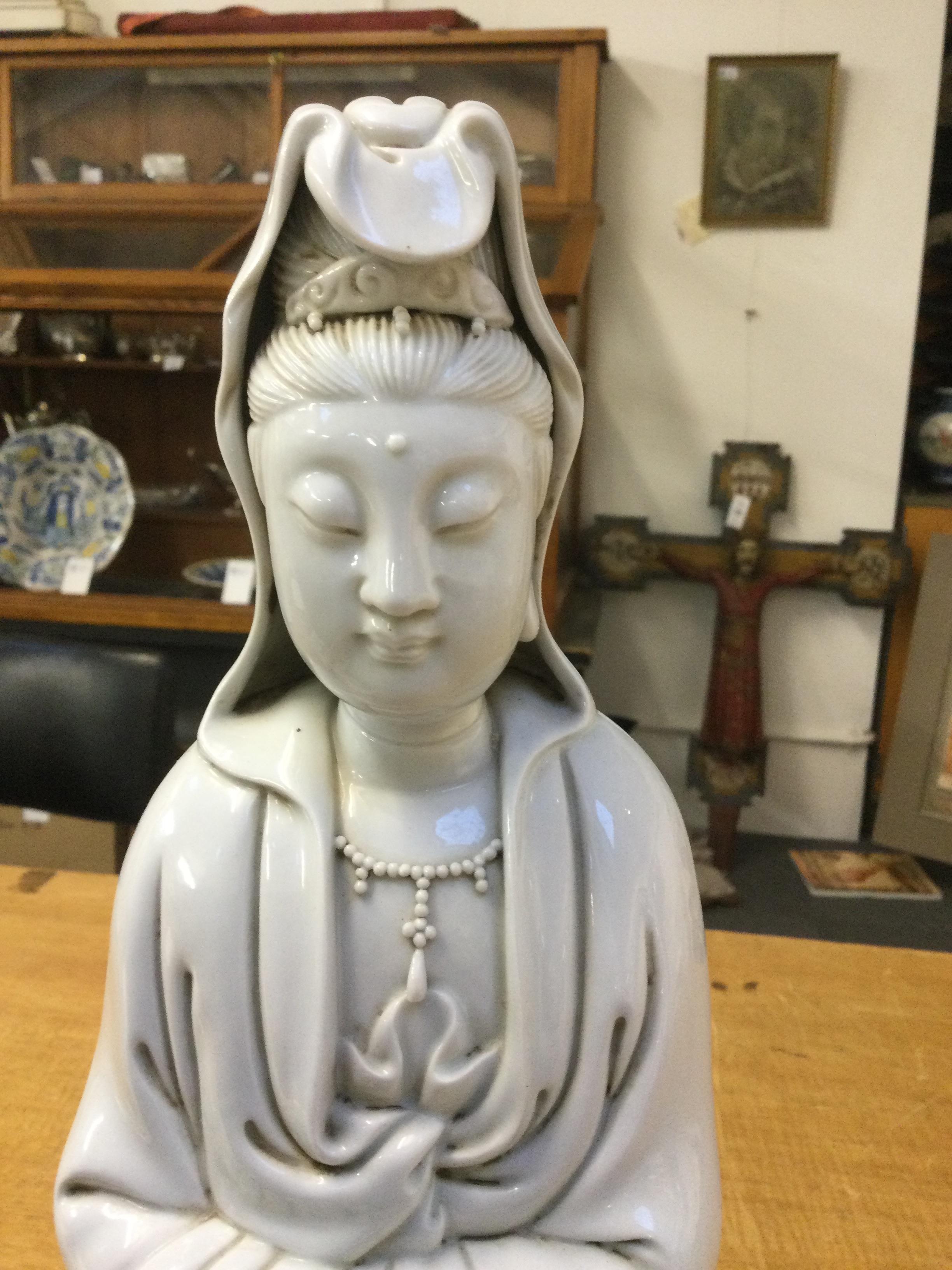 Lot 57 - Guanyin. Dehua monochrome white glazed figure