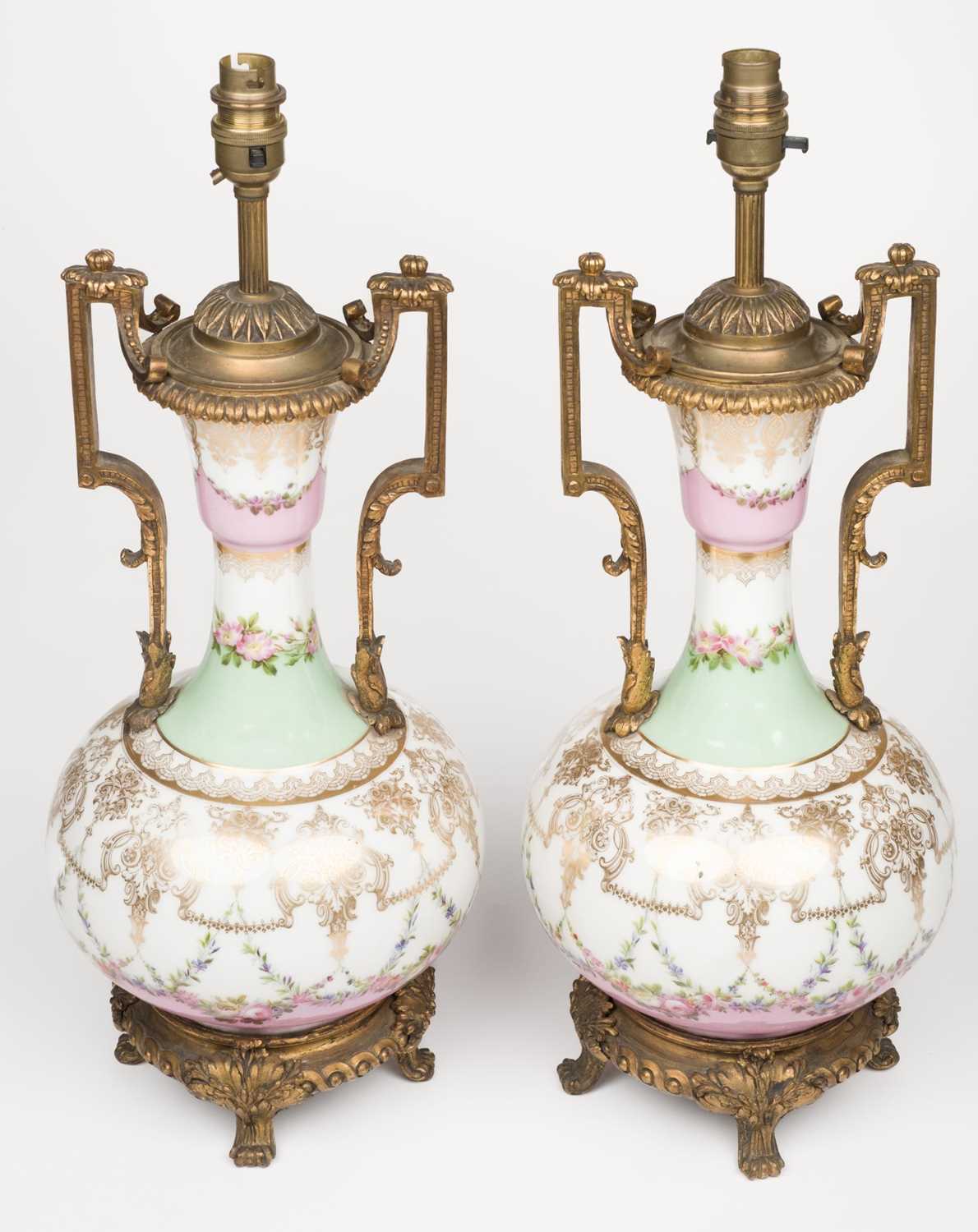Lot 589 - Table lamps. A pair of continental porcelain